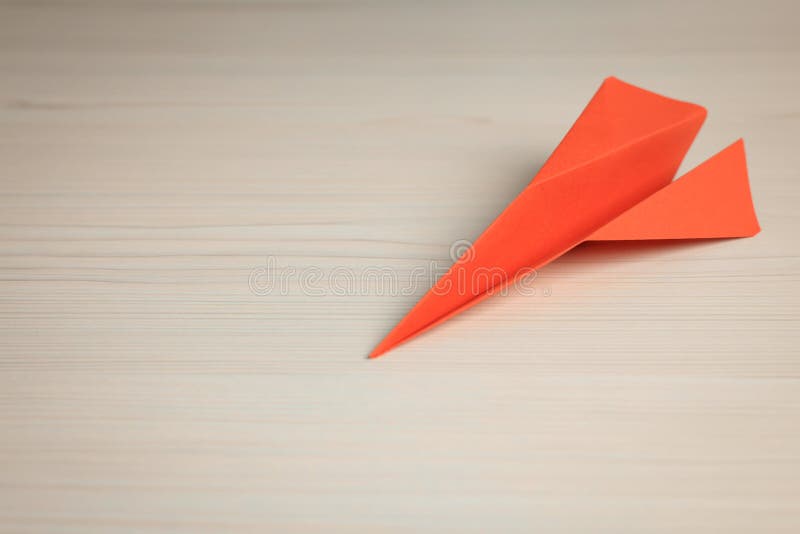 Handmade Orange Paper Plane on Beige Wooden Table. Space for Text Stock ...