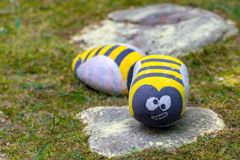 Handmade Painted Acrylic Stone Bee in Garden Stock Photo - Image of ...
