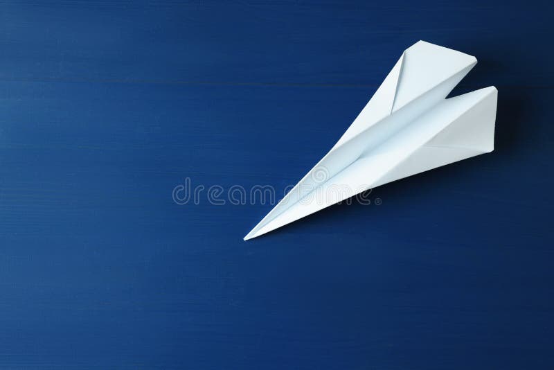 Handmade Paper Plane on Blue Wooden Table. Space for Text Stock Photo ...