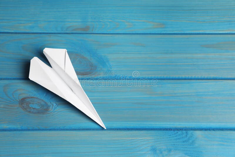 Handmade Paper Plane on Light Blue Wooden Table, Top View. Space for ...