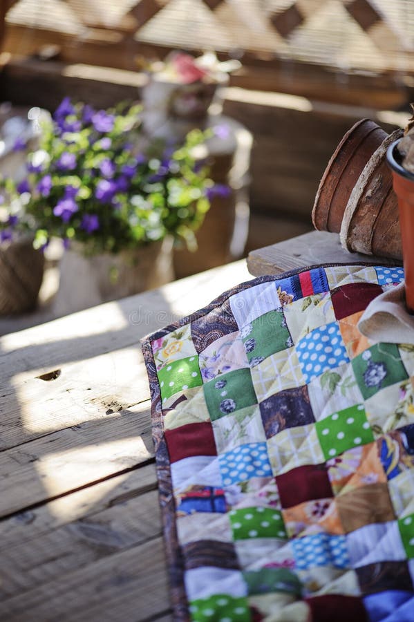 Handmade Patchwork Blanket on Wooden Table with Spring Flowers on ...