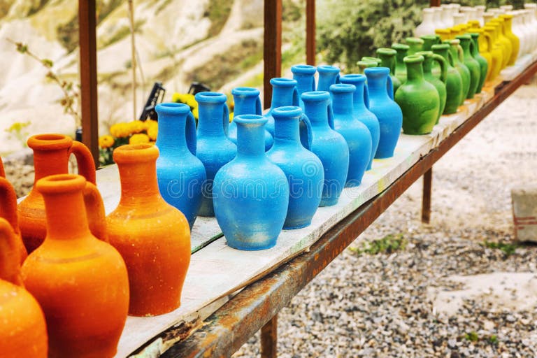 Handmade Pitchers of Different Colors on a Wooden Table Stock Image ...