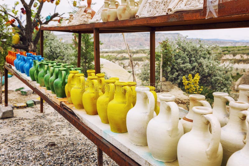 Handmade Pitchers of Different Colors on a Wooden Table Stock Photo ...