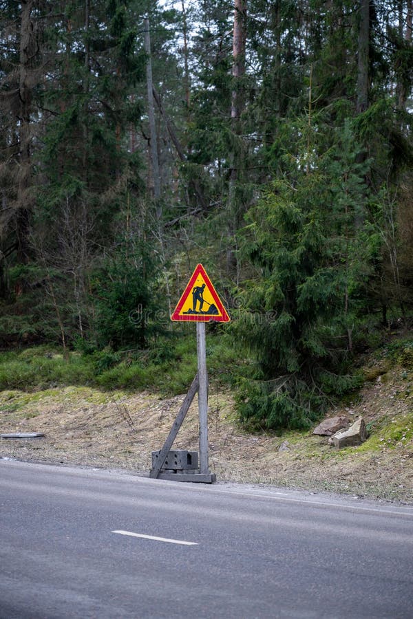 Handmade Roadwork Sign with Wooden Support by a Roadside in a Forest ...