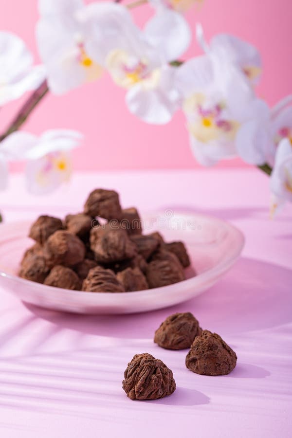 Handmade Rustic Chocolate Truffles with White Orchid Flowers on Pink ...