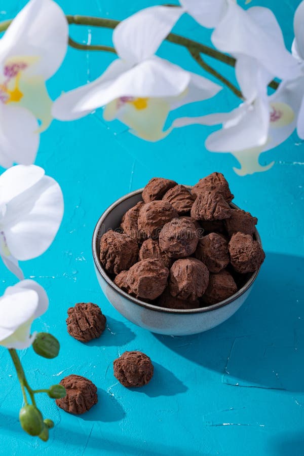 Handmade Rustic Chocolate Truffles with White Orchid Flowers on ...