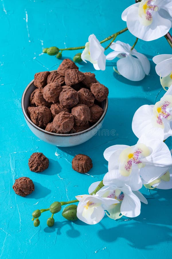 Handmade Rustic Chocolate Truffles with White Orchid Flowers on ...