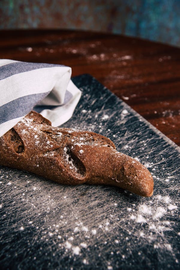 Handmade Rye Bread Wrapped with a Cloth Over a Stone Table Stock Photo ...