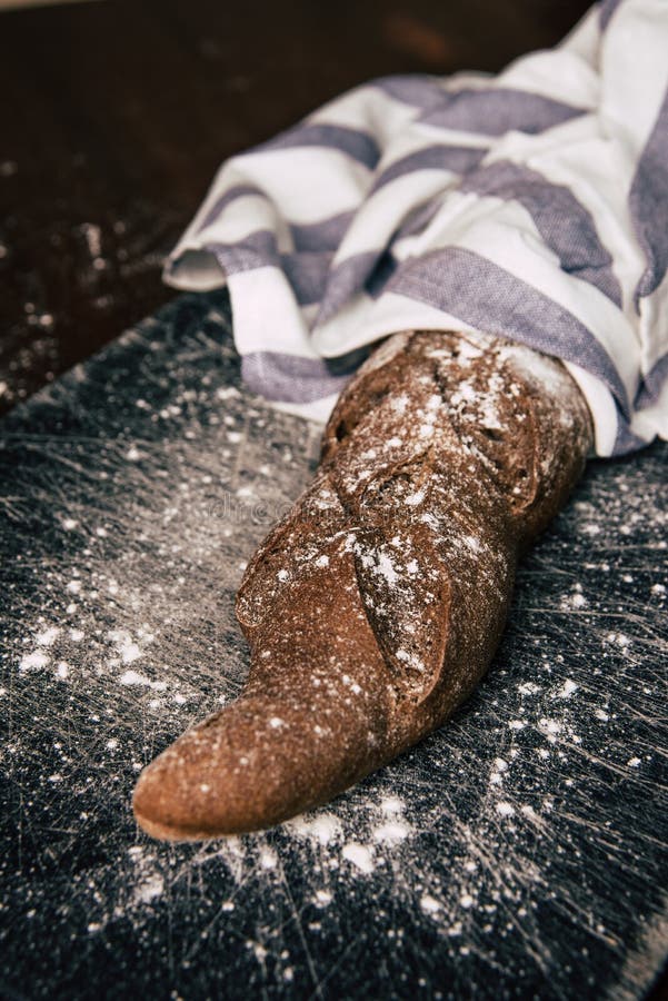 Handmade Rye Bread Wrapped with a Cloth Over a Stone Table Stock Photo ...