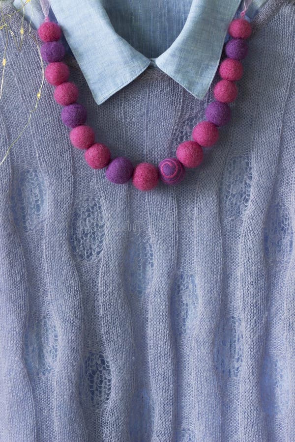 Handmade Wool Necklace on the Background of Clothes. Stock Photo ...