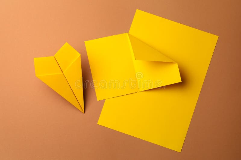 Handmade Yellow Plane and Pieces of Paper on Brown Background, Flat Lay ...