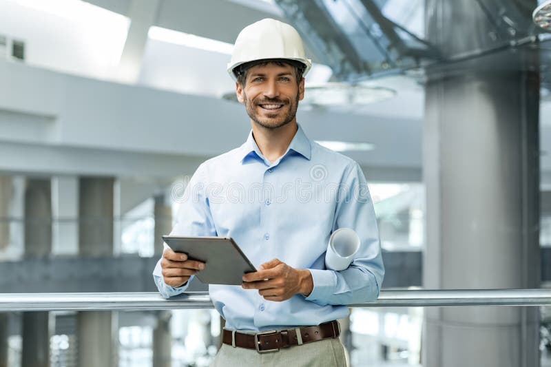 Handosme Man with Worker& X27;s Helmet Holding Digital Tablet while ...