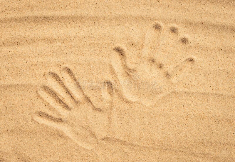 Handprints on sand stock image. Image of symbol, beach - 67095617