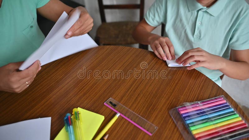 Two Students Folding Paper at a Wooden Table. Preparing for Back To ...