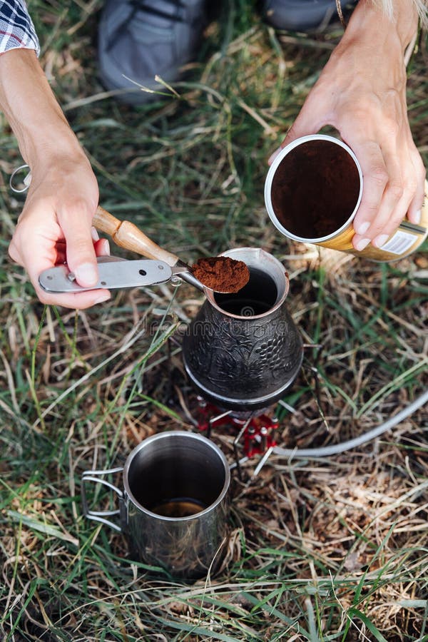 Hands Adding Coffee Powder in a Cezve with a Metal Folding Spoon Stock ...