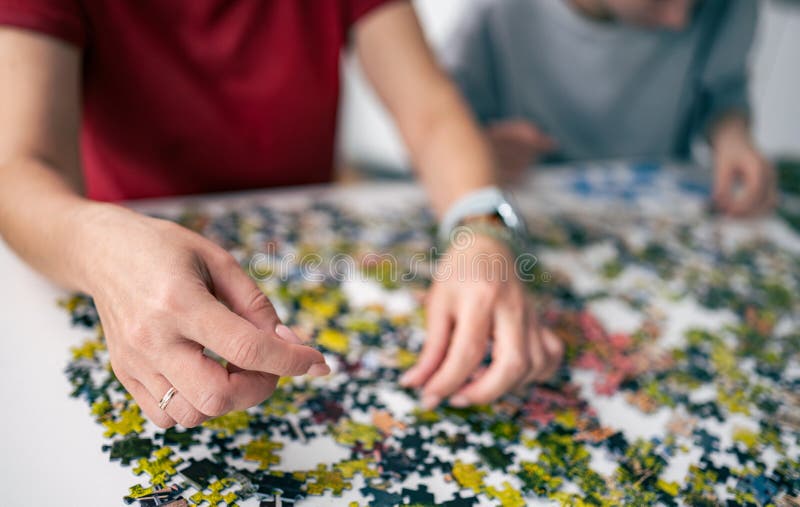 Hands Assembling Puzzle Pieces into Image Stock Photo - Image of pieces ...