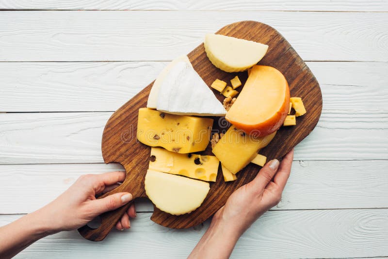 Hands and Assorted Cheese on Wooden Board Stock Image - Image of meal ...