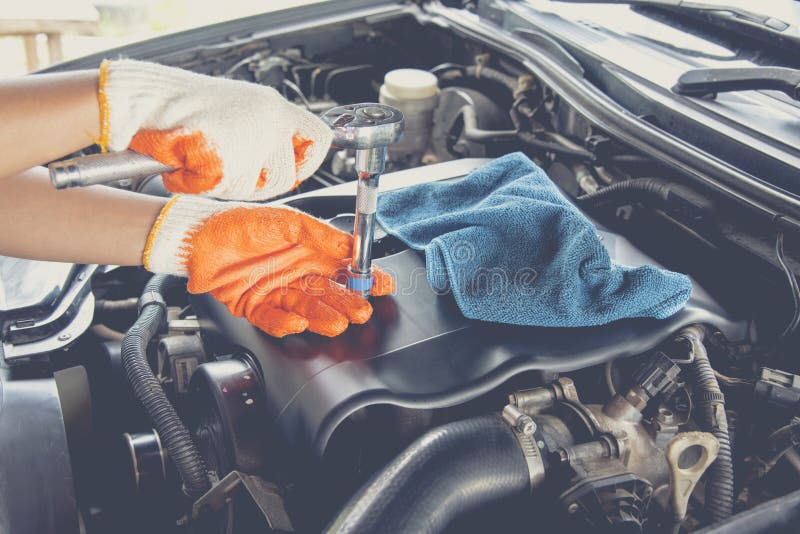 Hands of Auto Mechanic are Using the Wrench To Repair and Maintenance ...