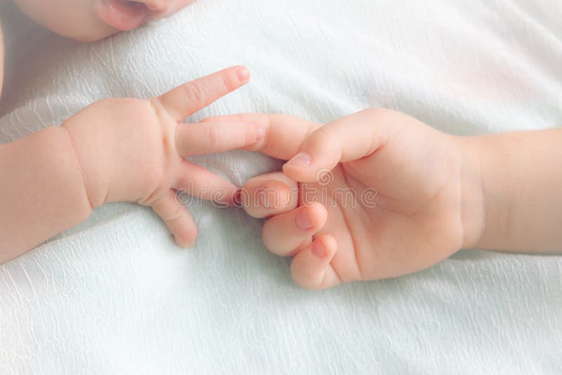 Hands of the Baby and Little Girl. Two Babies Hands Stock Image - Image ...