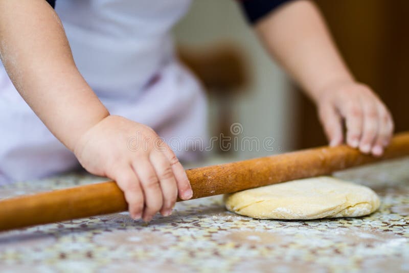Hands Baking Dough with Rolling Pin on Table. Little Chef Bake in ...