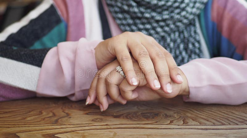 Elegant Hands Resting on a Wooden Table in a Cozy Setting Stock Footage ...
