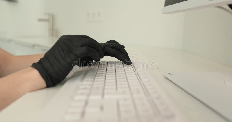 Hands in Black Nitrile Gloves Using Keyboard while Doing Work in Clinic ...