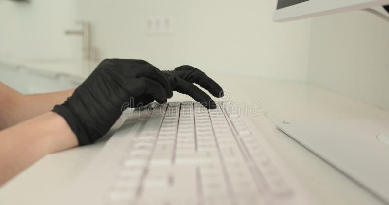 Hands in Black Nitrile Gloves Using Keyboard while Doing Work in Clinic ...