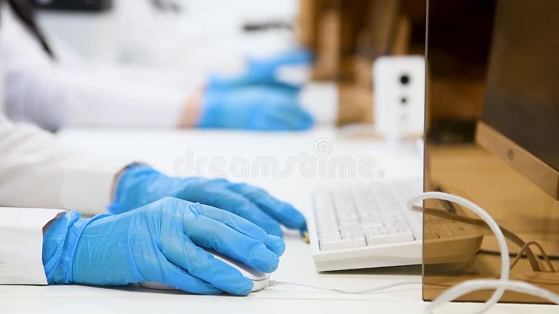 Hands with Blue Nitrile Gloves Using a Laptop Keyboard, Performing ...