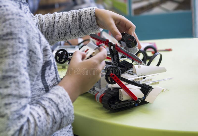 Hands of the Boy Collecting the Robot Stock Photo - Image of equipment ...