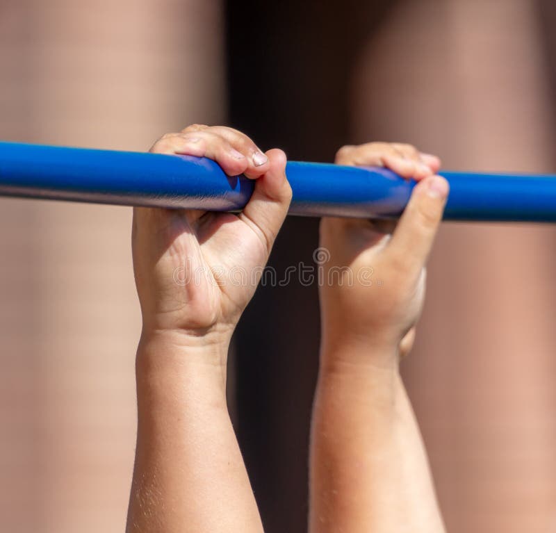 Hands of a Boy Hold on To the Horizontal Bar Stock Image - Image of ...