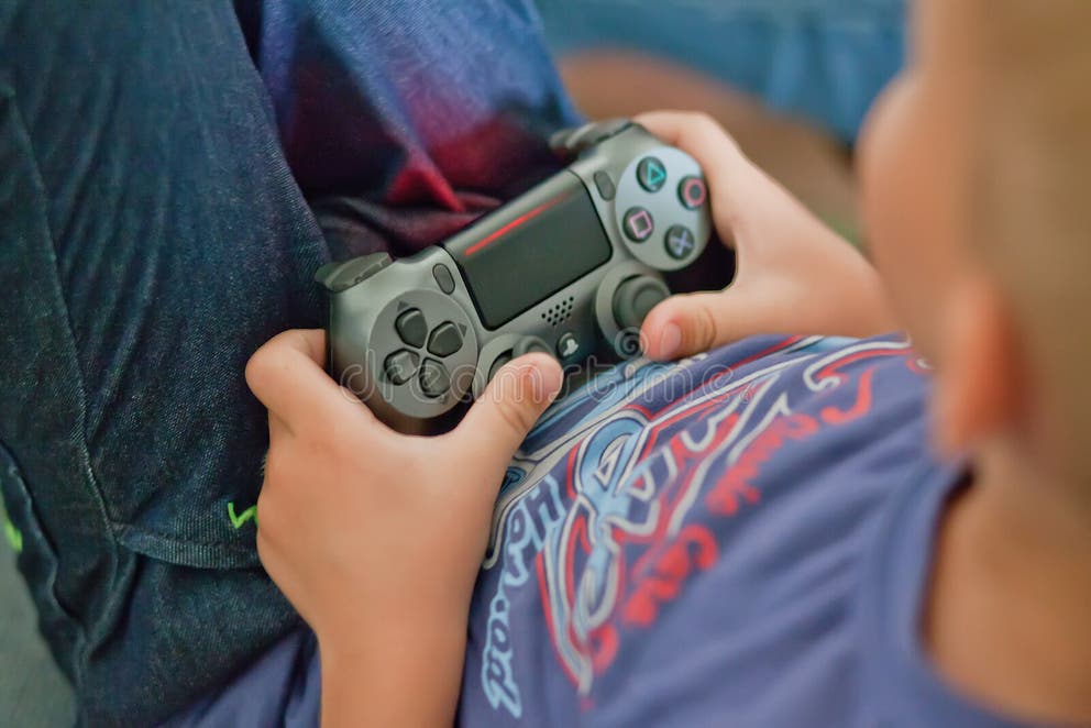 Hands of a Boy Kid Holding a Black Console Pad Controller Joystick and ...