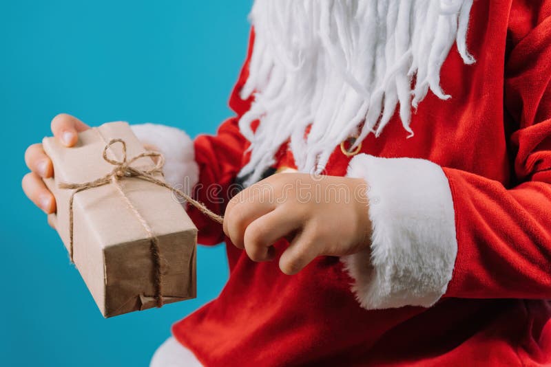 Hands of Boy in Santa S Costume Pulling on String of Wrapped Gift Box ...
