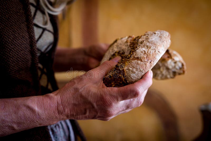 Hands breaking bread stock photo. Image of aged, apron - 273872304