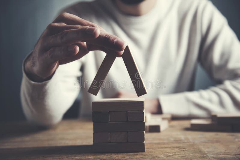 Hands build house of cubes stock image. Image of brick - 256275793