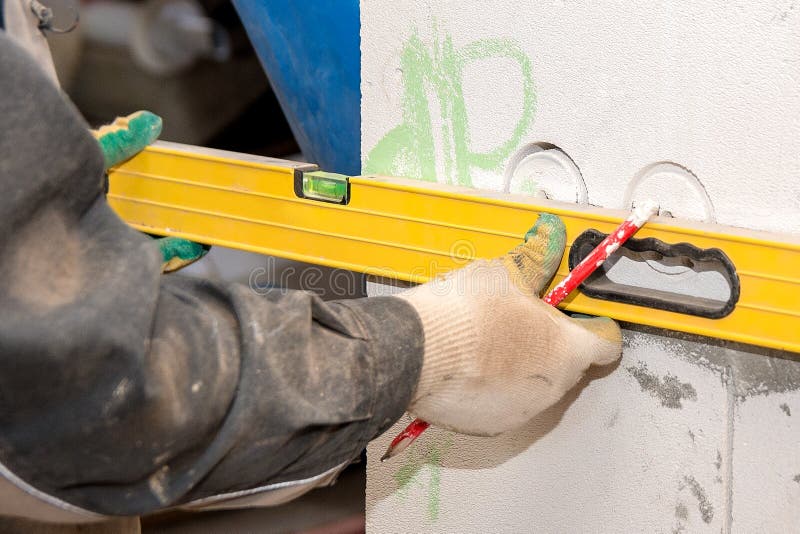 Hands Builder Measure the Level of the Wall in the House Under ...