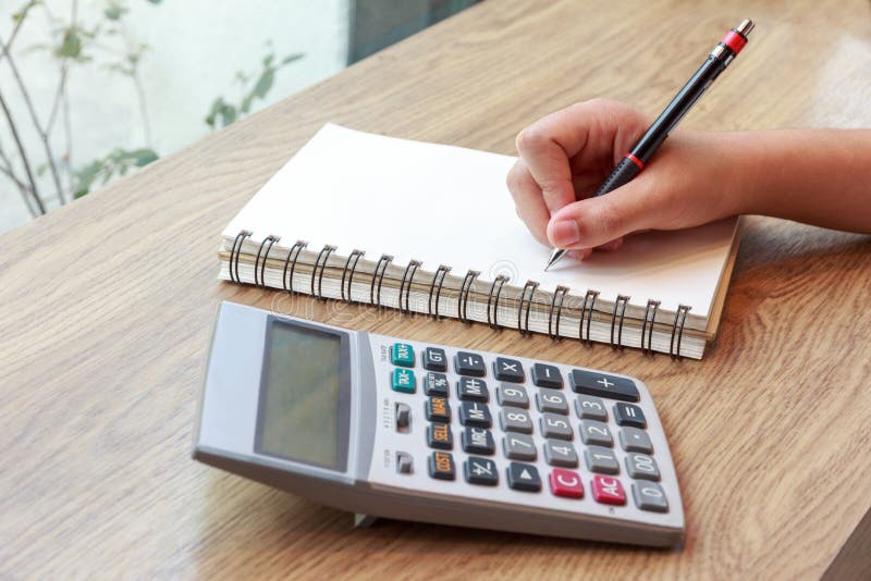 Hands of Business Woman Writing on Notebook with Calculator Stock Image ...