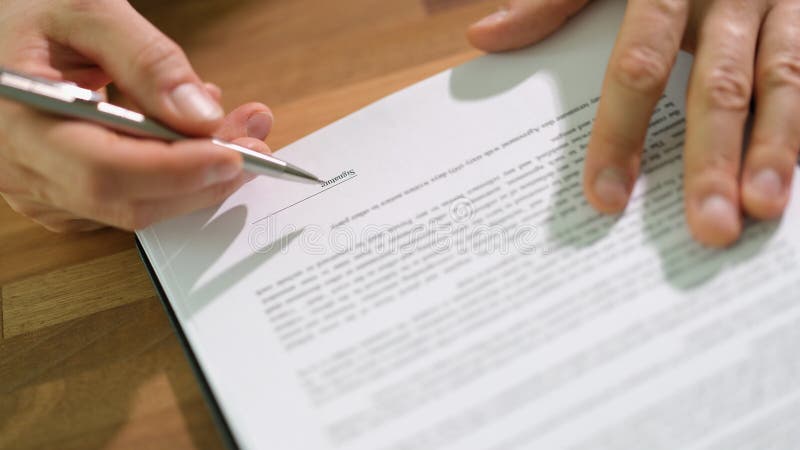 Hands of Businessman with Pen Signing Contract Document at Table ...