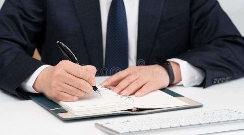 Hands of a Businessman Writing a Schedule or Recording Ideas in a Diary ...