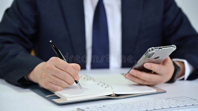 Hands of a Businessman Writing a Schedule or Recording Ideas in a Diary ...
