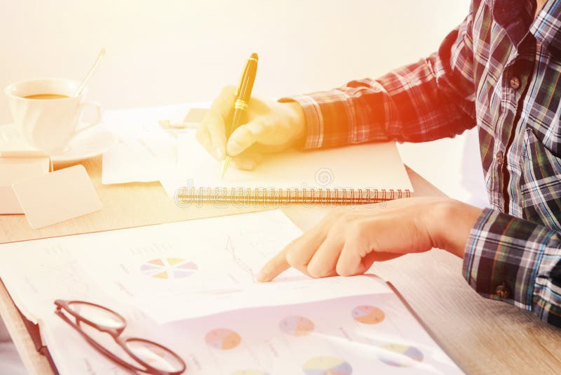 Hands of Businessman Writing Something on Notebook Paper, and Business ...