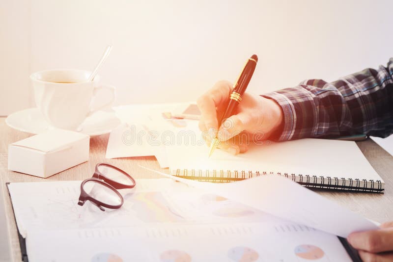 Hands of Businessman Writing Something on Notebook Paper, and Business ...