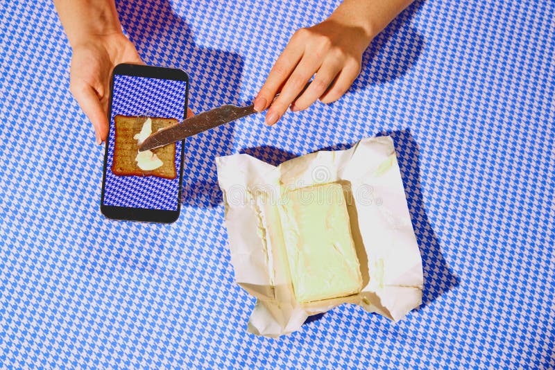 Hands Buttering Virtual Toast on a Smartphone Screen with Real Butter ...