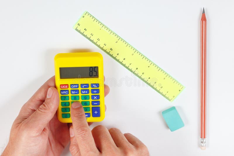 Hands Calculate Using a Pocket Digital Calculator Over a Workplace of ...