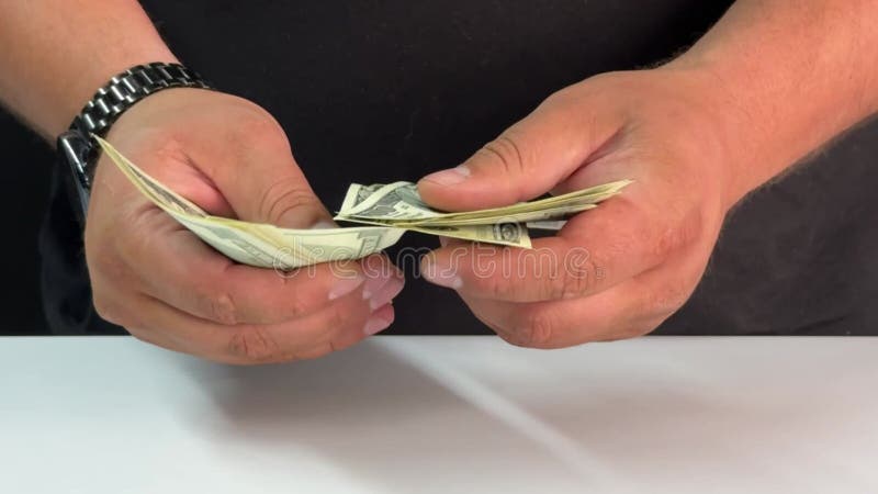 Hands Carefully Sort through a Stack of Dollar Bills at a Table ...