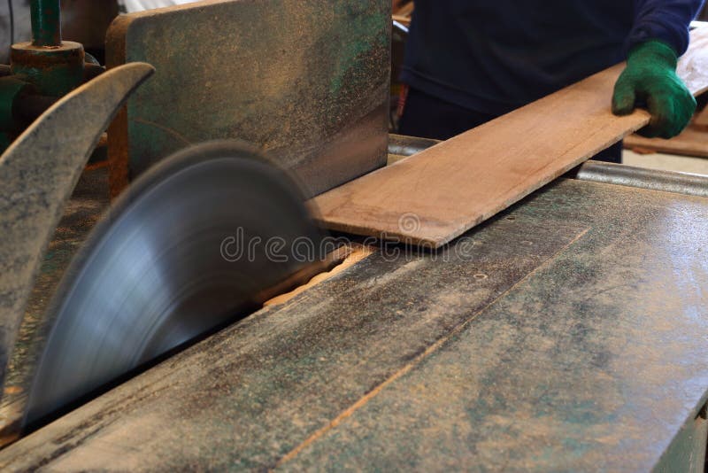 Hands of Carpenter Sawing a Piece of Wood on a Table Saw Stock Image ...