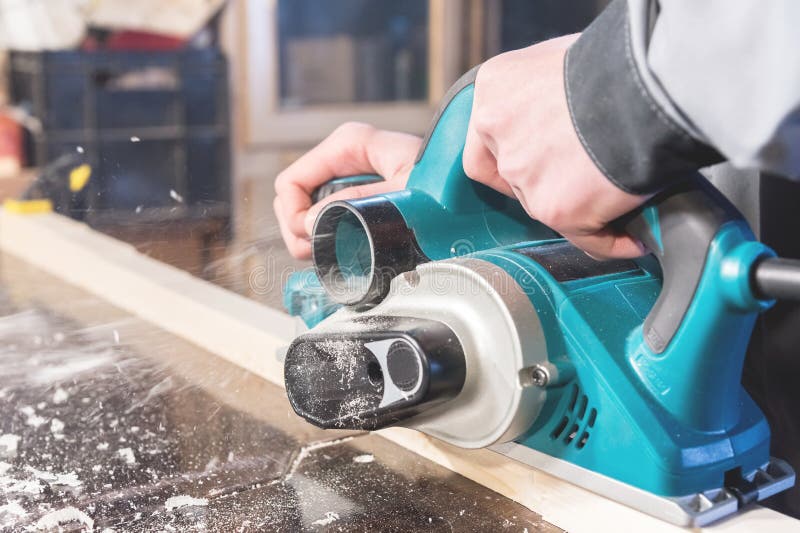 The Hands of a Carpenter Working Woodworking Power Tools. Close Up of ...