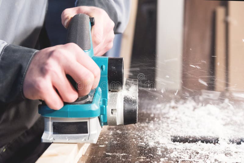 The Hands of a Carpenter Working Woodworking Power Tools. Close Up of ...