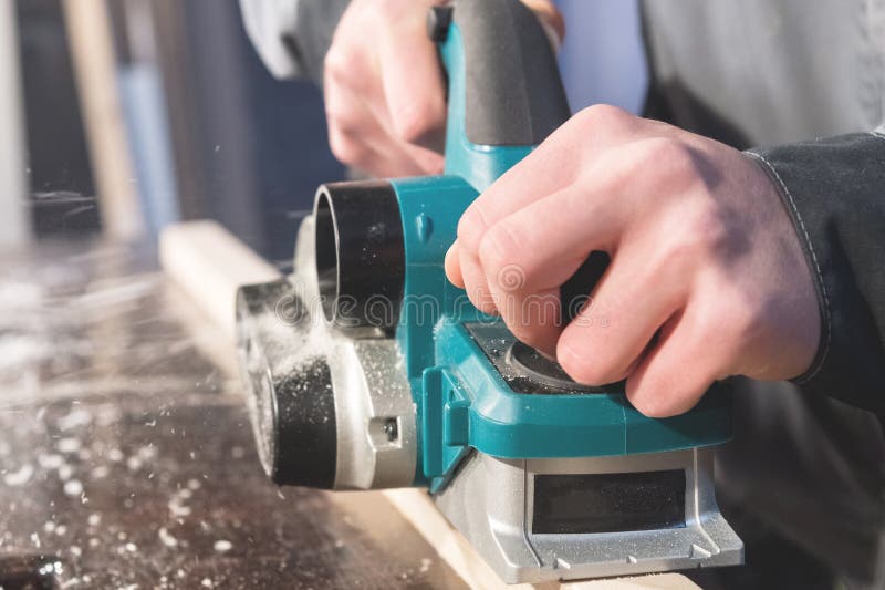 The Hands of a Carpenter Working Woodworking Power Tools. Close Up of ...