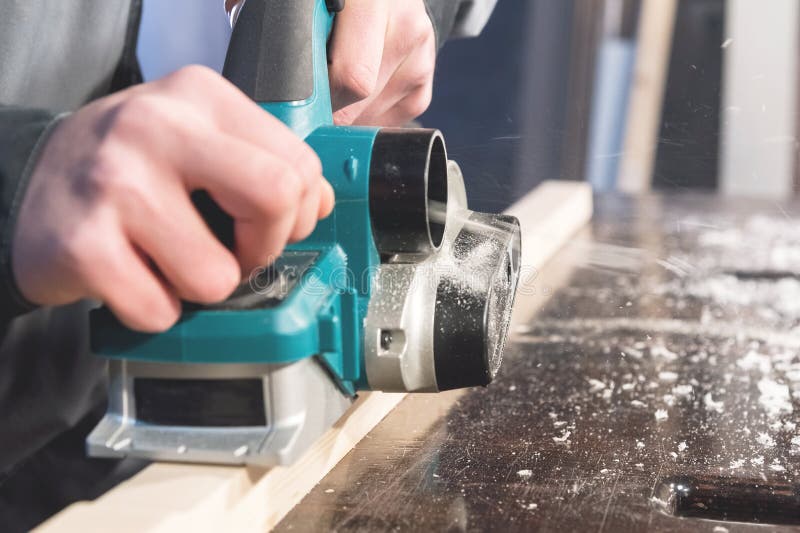 The Hands of a Carpenter Working Woodworking Power Tools. Close Up of ...