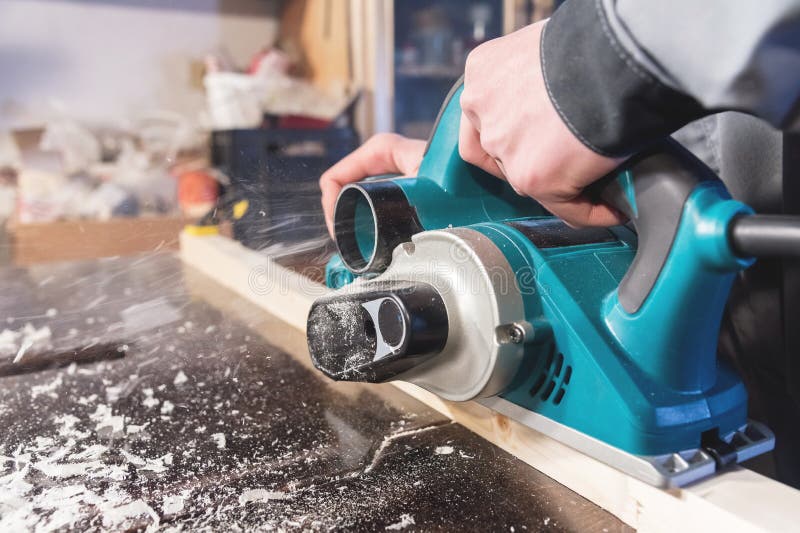 The Hands of a Carpenter Working Woodworking Power Tools. Close Up of ...